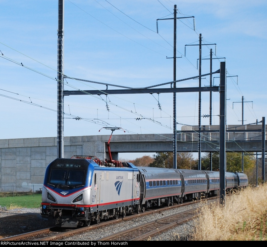 Amtrak train 663 is westbound past the Maibach Road bridge